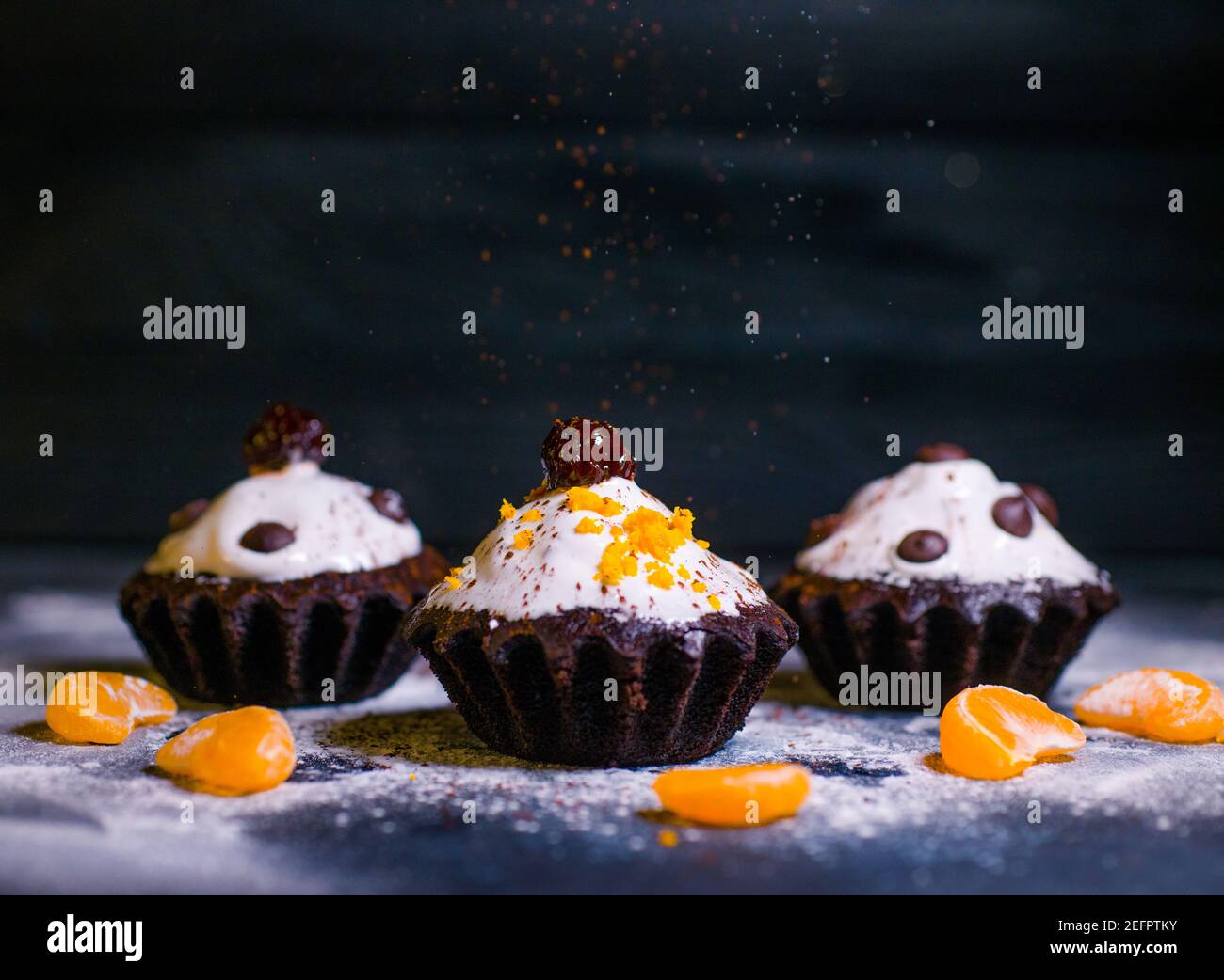 chocolate muffins sprinkled with goodies with cherries and chocolate ...