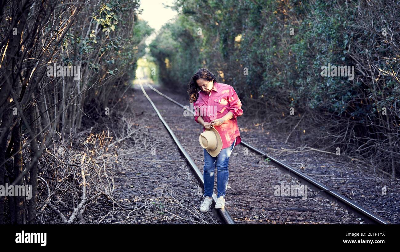 Beautiful Young Woman Standing By Train Tracks Young woman walking on ...