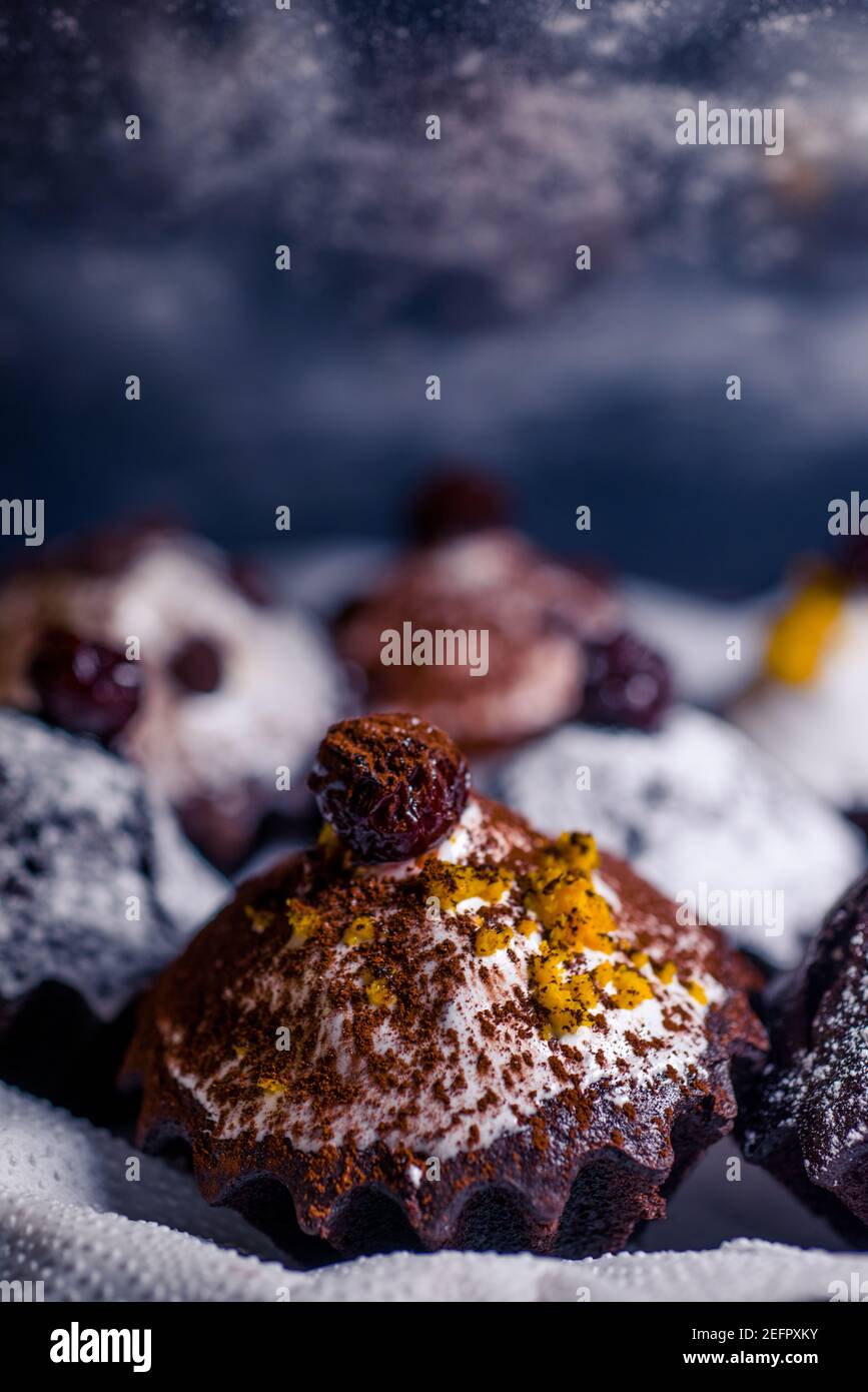 chocolate muffins sprinkled with goodies with cherries and chocolate ...