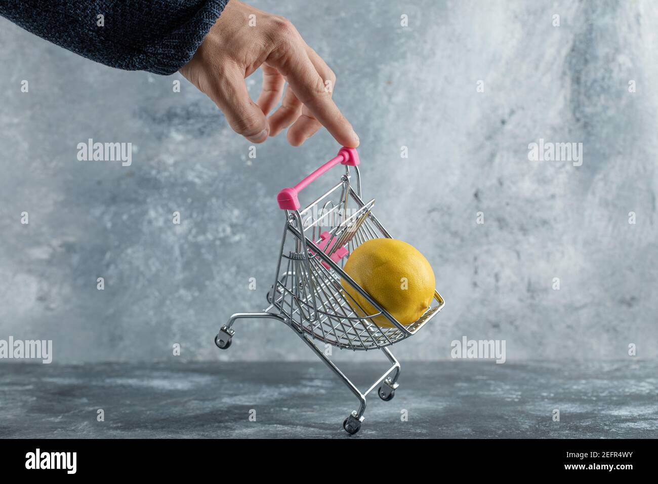 Hand holding shopping cart hi-res stock photography and images - Alamy