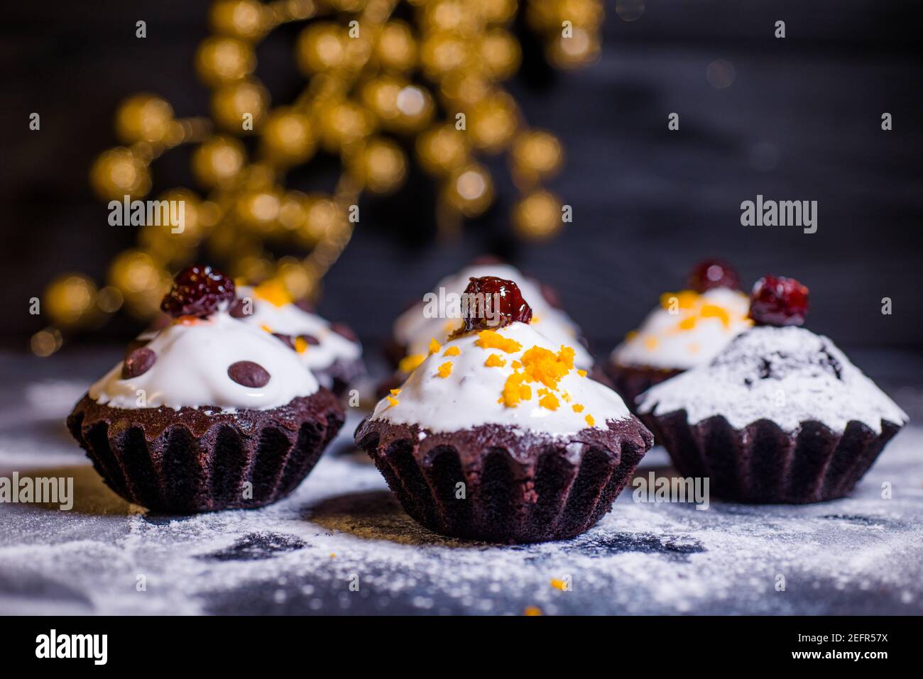 chocolate muffins sprinkled with goodies with cherries and chocolate ...