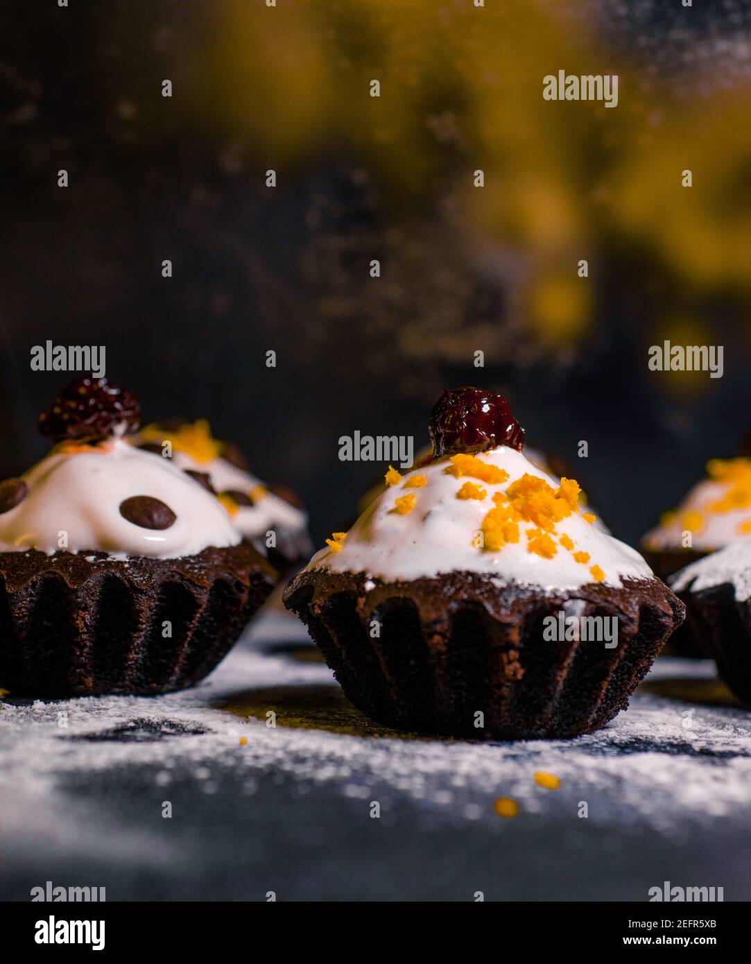 chocolate muffins sprinkled with goodies with cherries and chocolate ...
