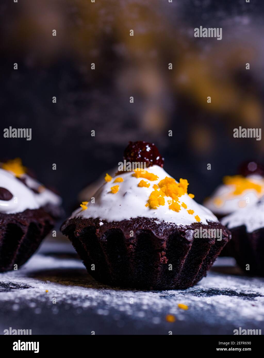 chocolate muffins sprinkled with goodies with cherries and chocolate ...