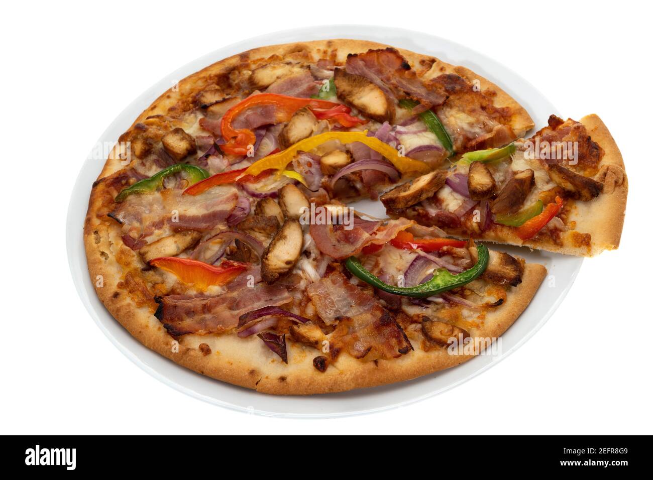 A meat feast pizza with a slice removed viewed from above - white ...