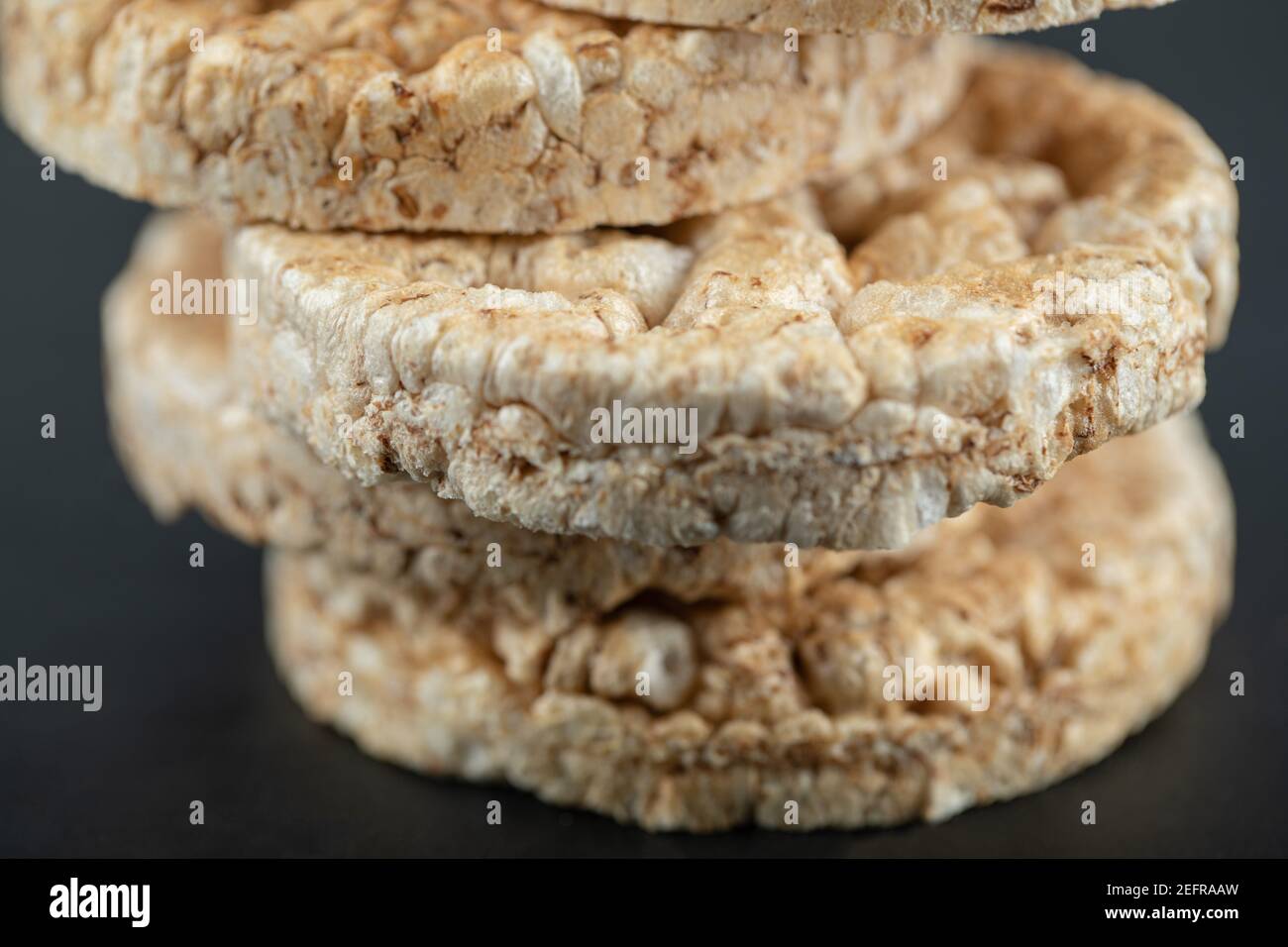 Pile of crispy rice cakes on black background Stock Photo - Alamy