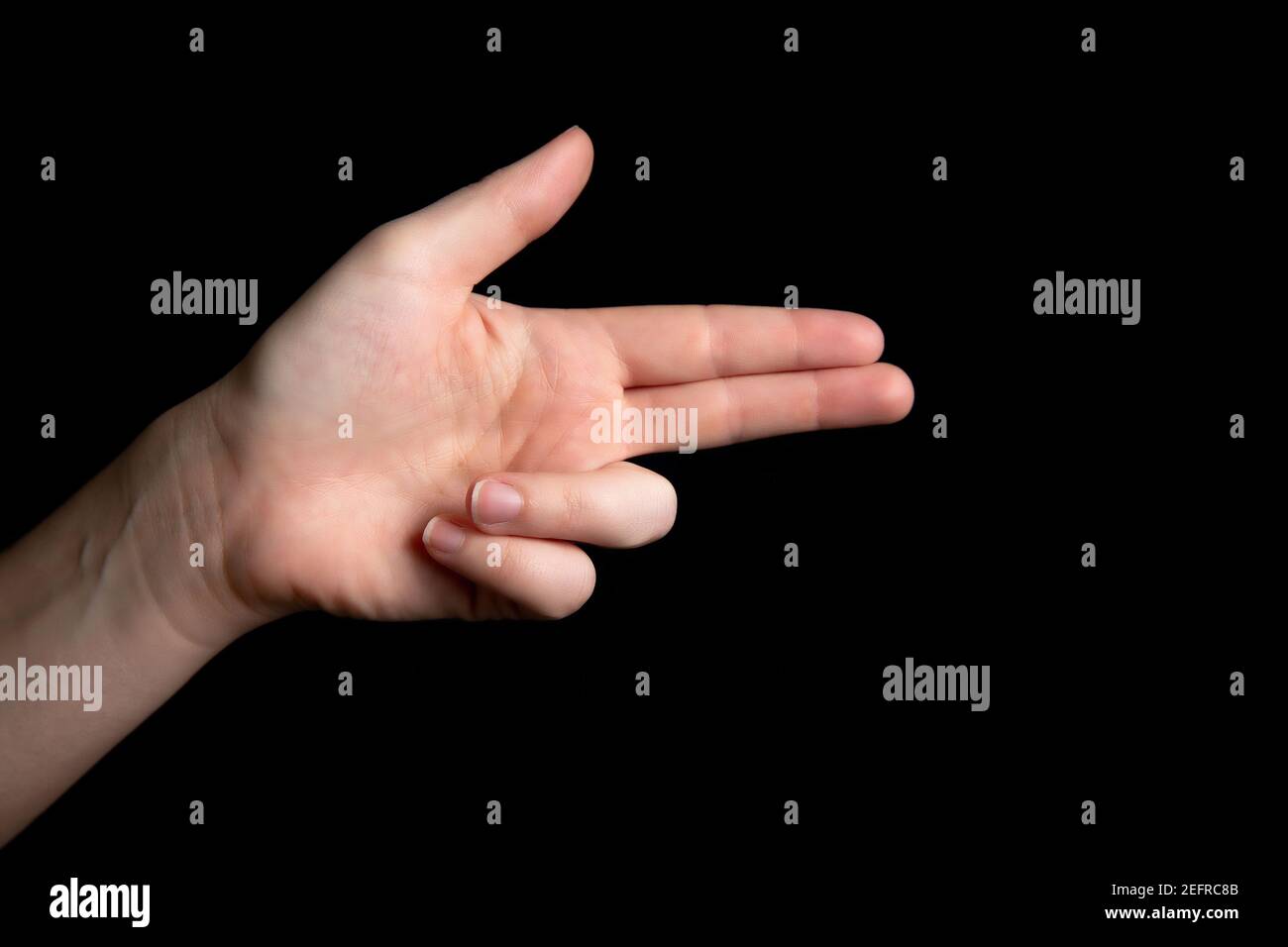 Person Holding symbolic gun with hand gesture, playing killing shooting ...