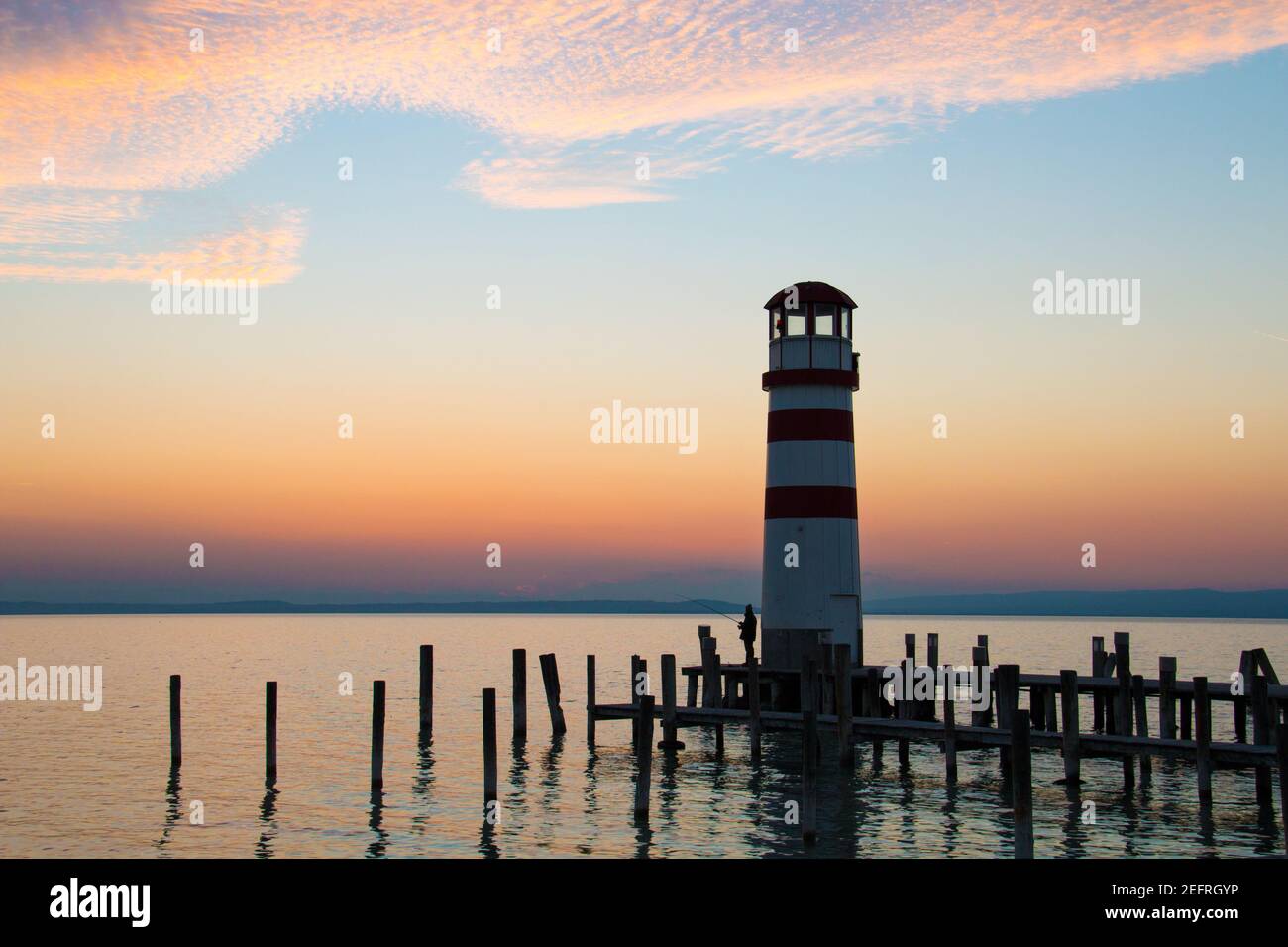 Low horizon romantic sunset sky over the lake landscape with red white ...