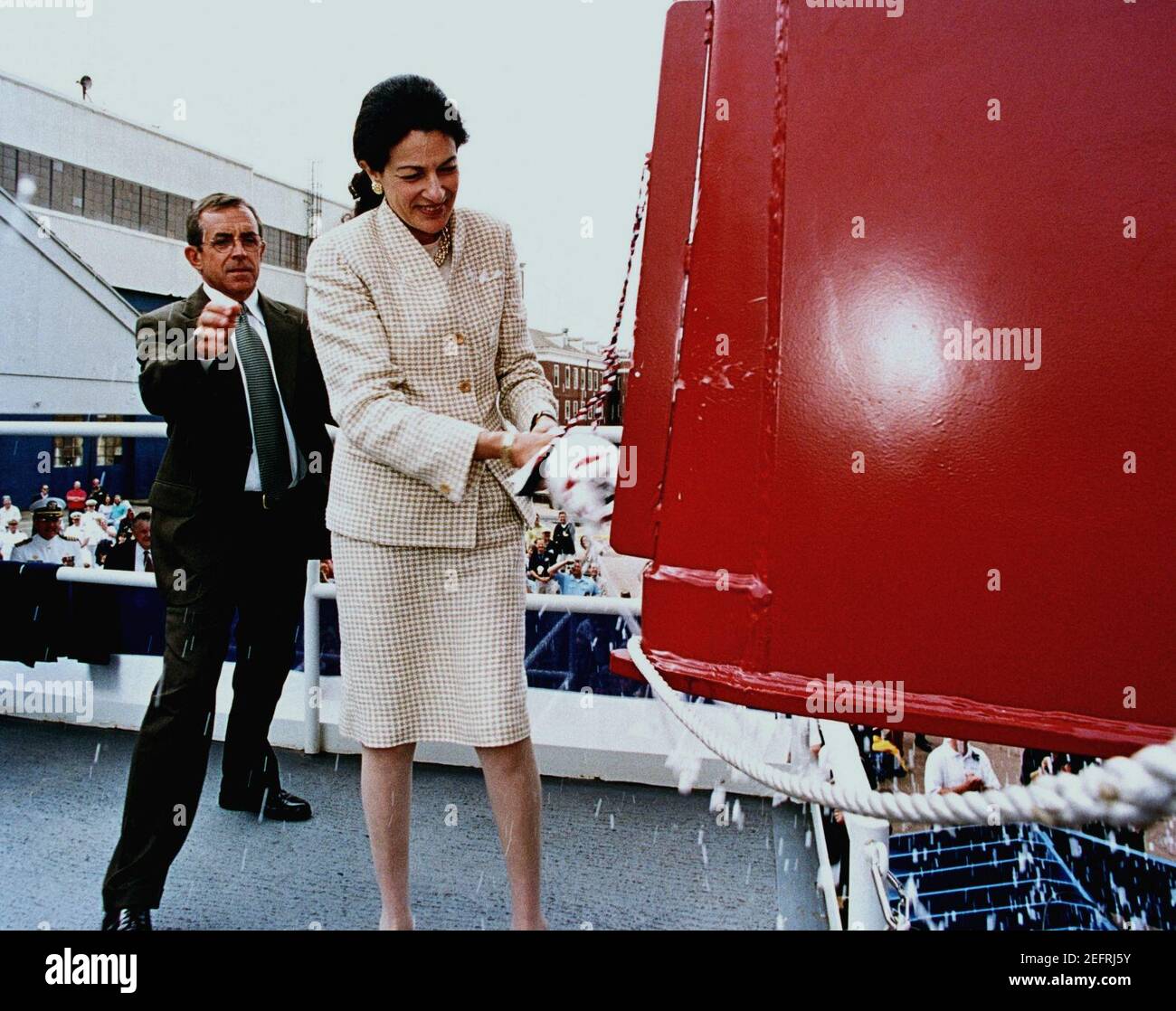 Olympia Snowe breaks the traditional bottle of champagne across the bow ...