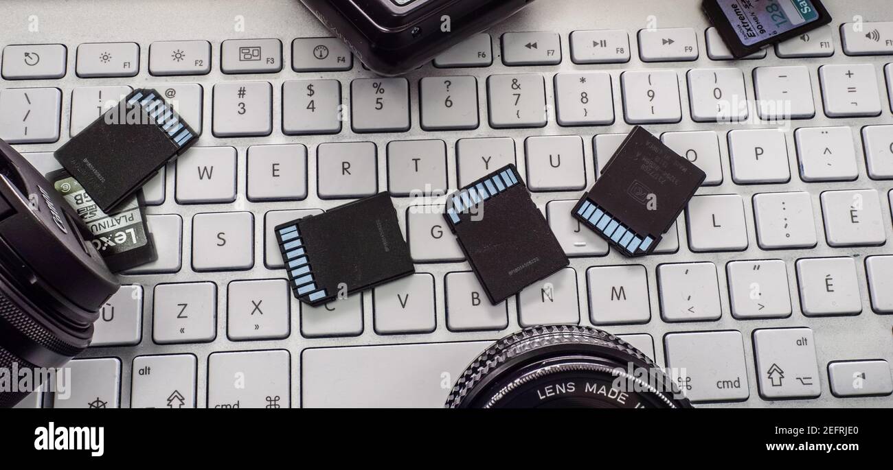 On the keyboard you see some SD cards and parts of photo gear Stock ...