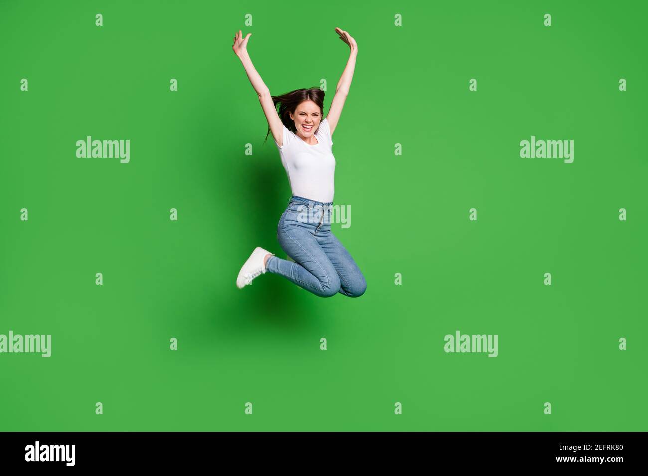 Full size photo of careless girl jump raise arms wear casual style ...