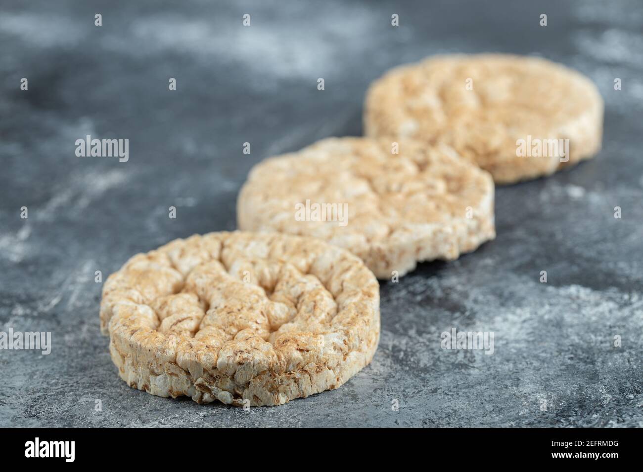 Three puffed rice cakes on marble background Stock Photo - Alamy