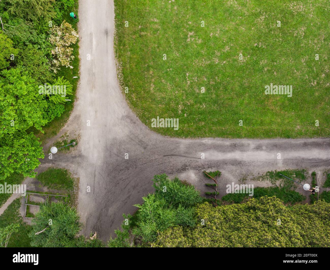 Top down look to connection of paths between grass, bushes and trees ...