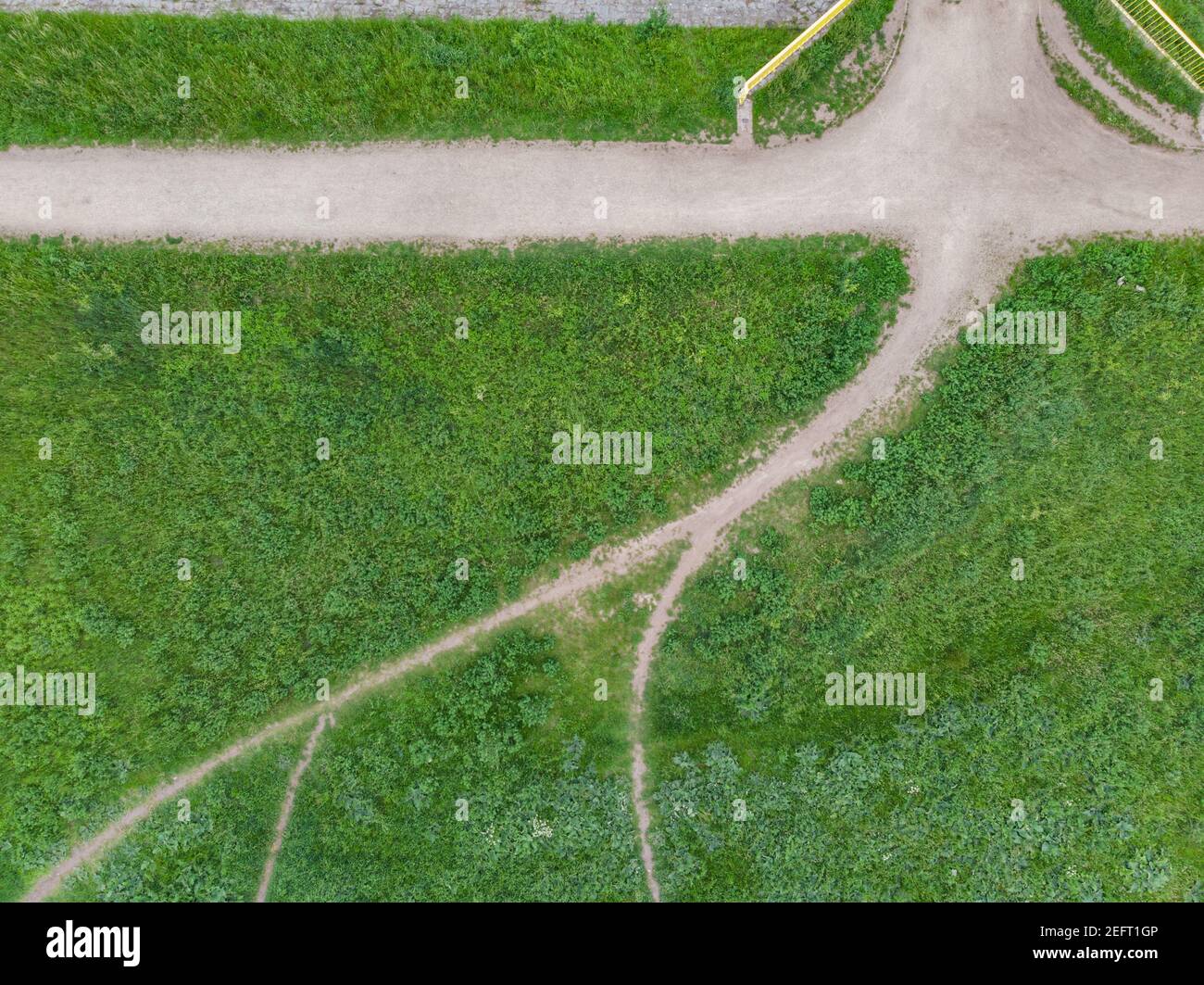 Top down look to connection of paths between grass and bushes Stock ...