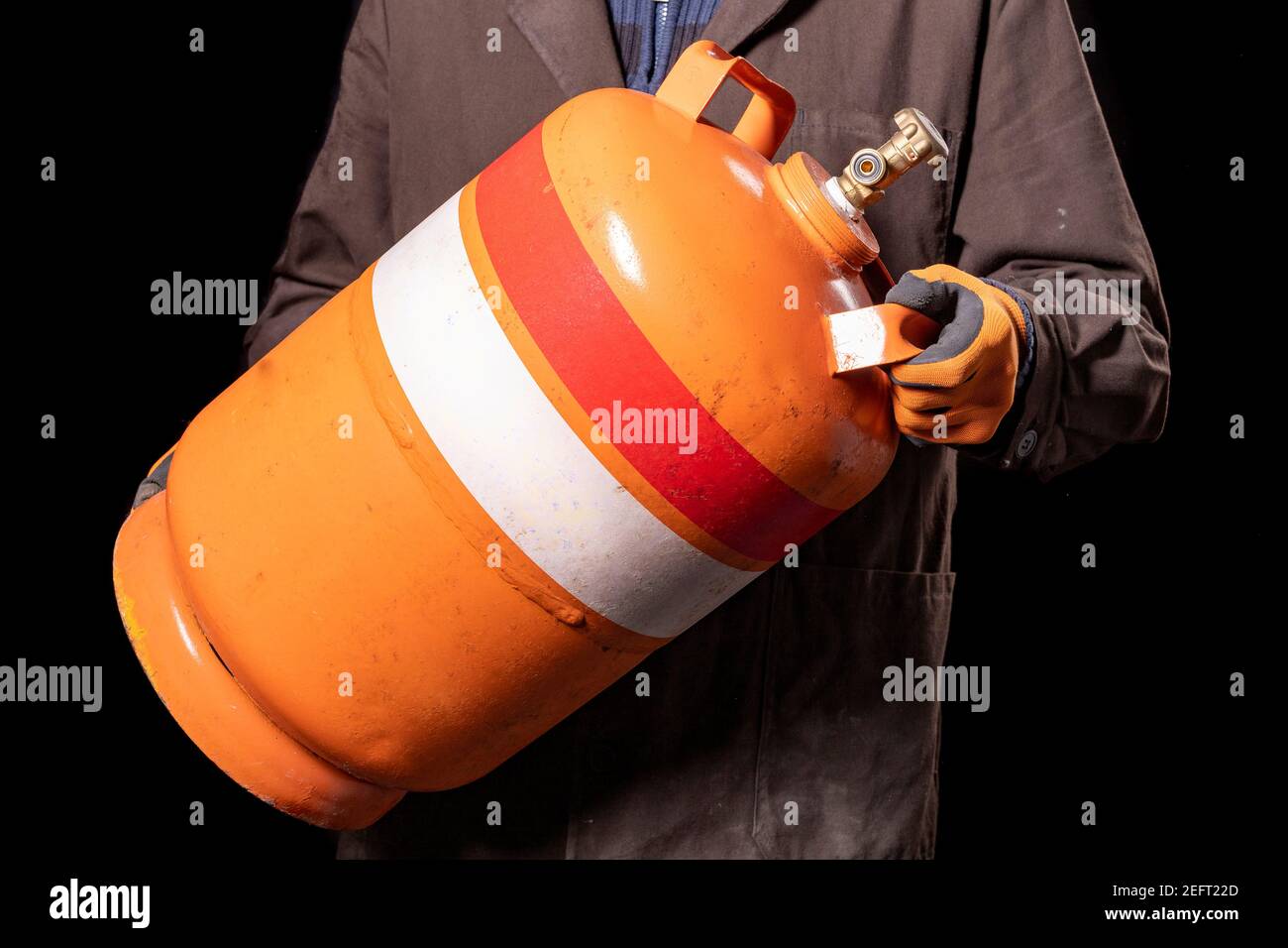 A production worker with a gas cylinder. Man carrying dangerous ...