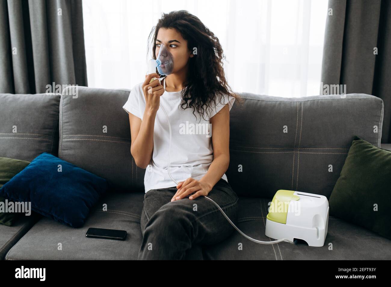 Sick african american woman with an inhaler. Unhealthy african american ...