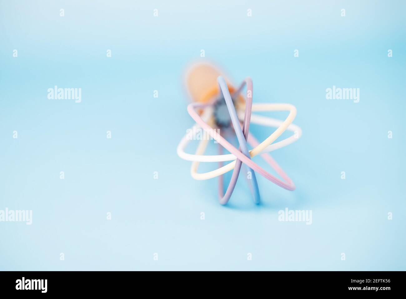 Colored plastic whisk for whipping on a light blue background, copy ...