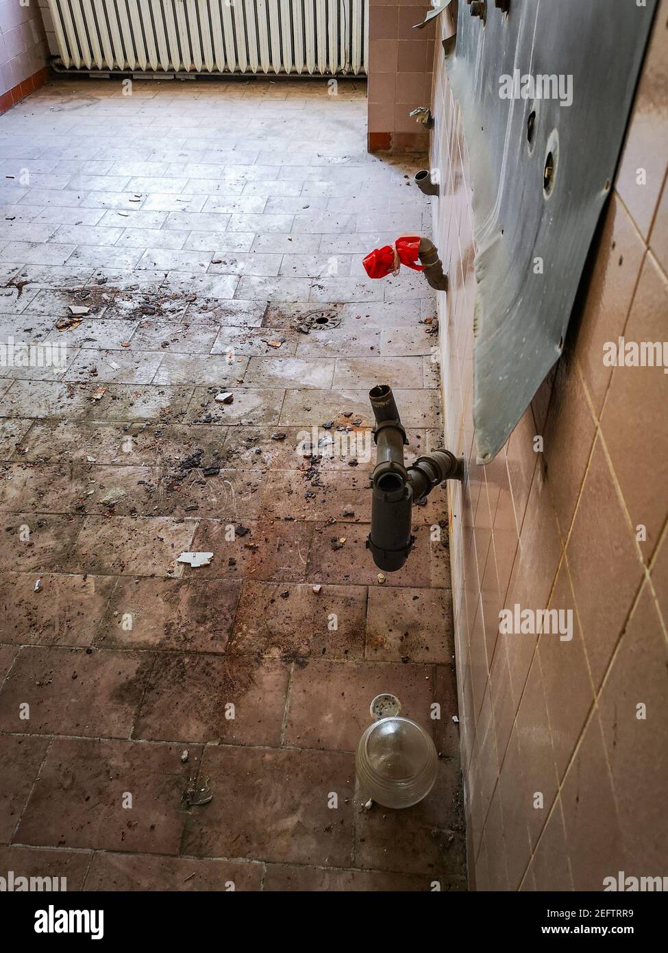 Water pipes out of the wall in destroyed room in old abandoned hospital ...
