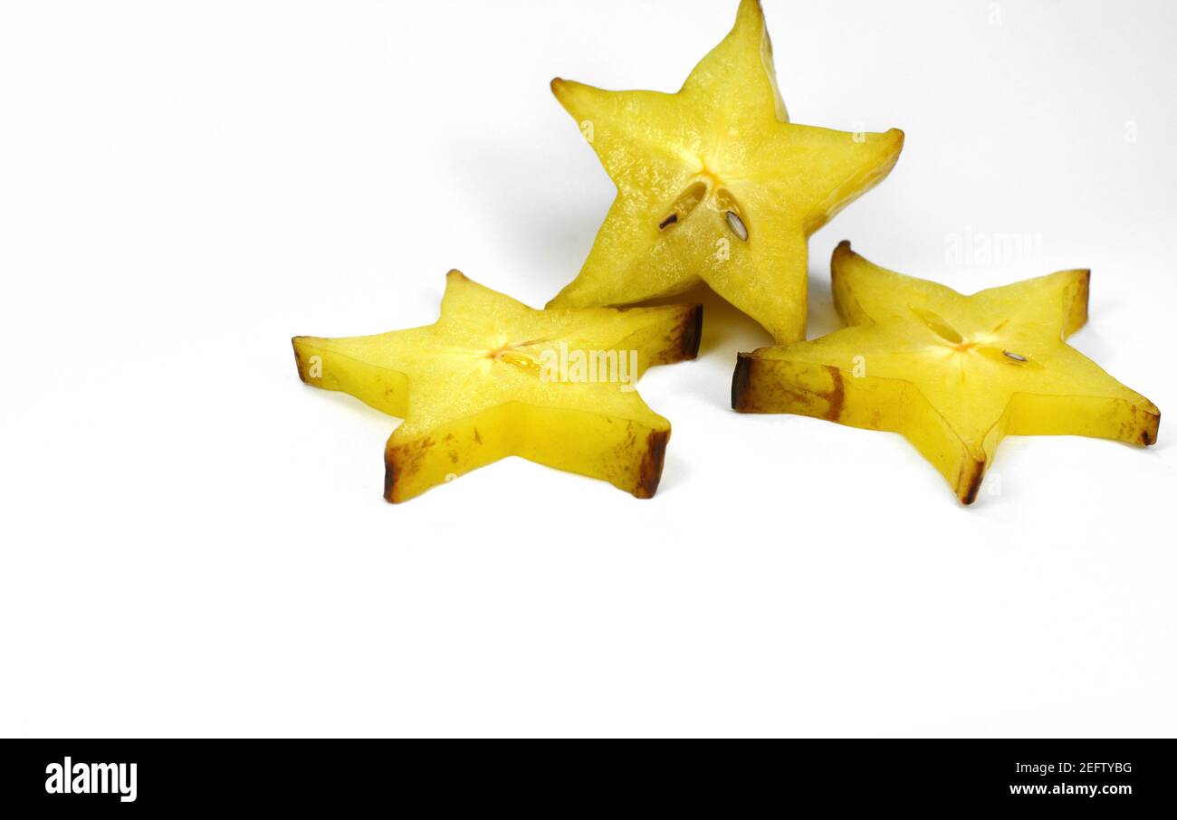 Star shaped slices of carambola fruit isolated on white background ...