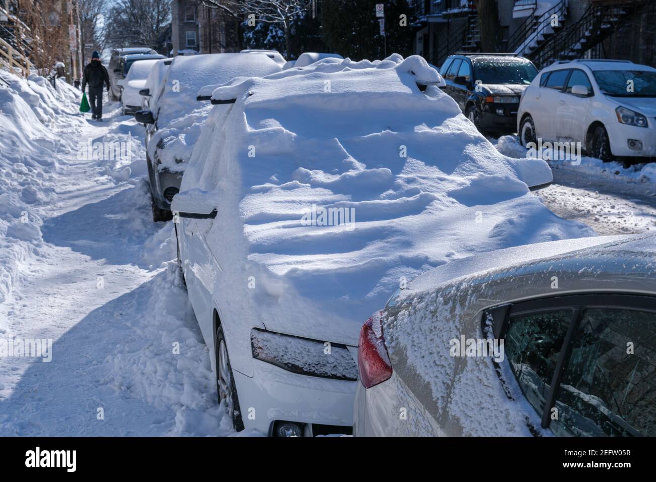 City street and cars covered in snow after snowfall in Montreal, Canada ...