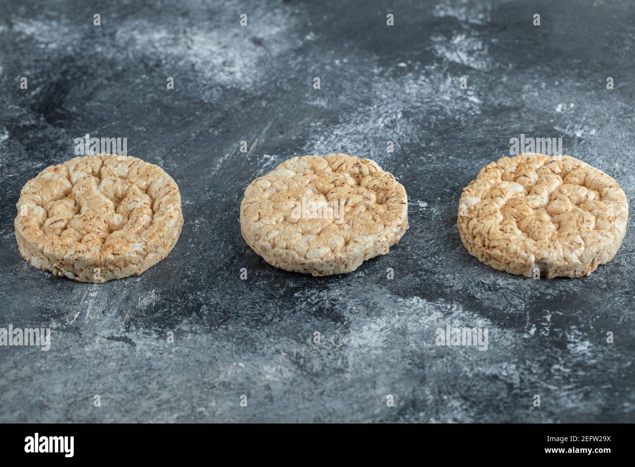 Three puffed rice cakes on marble background Stock Photo - Alamy