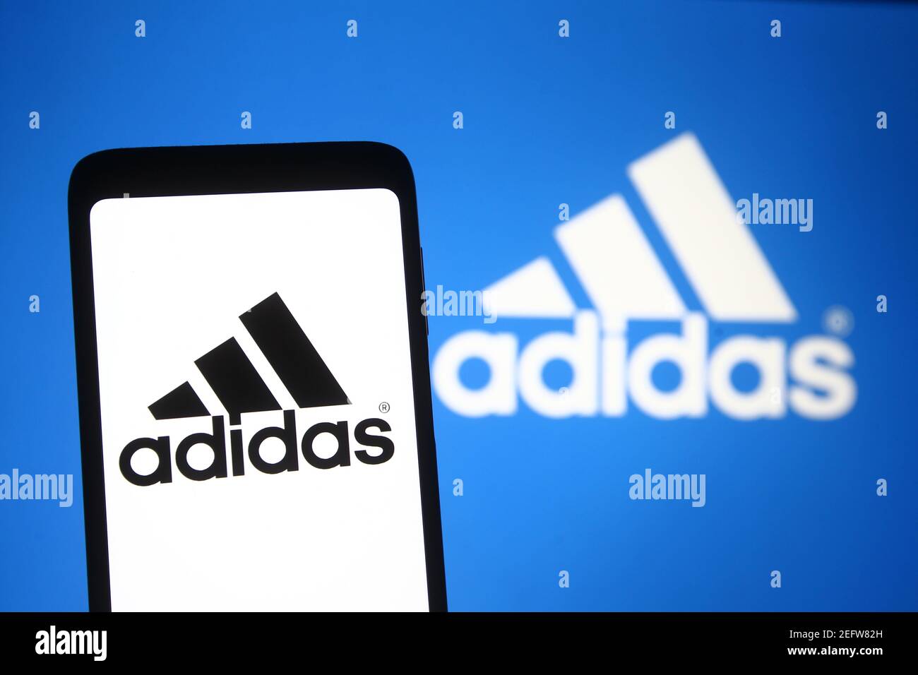 In this photo illustration the Adidas logo is seen on a smartphone and ...