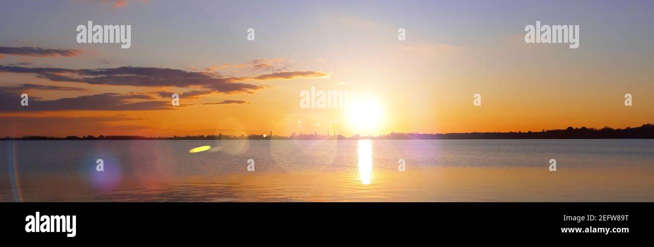 Sunset on the lake. Sunset scene over lake water surface Stock Photo ...