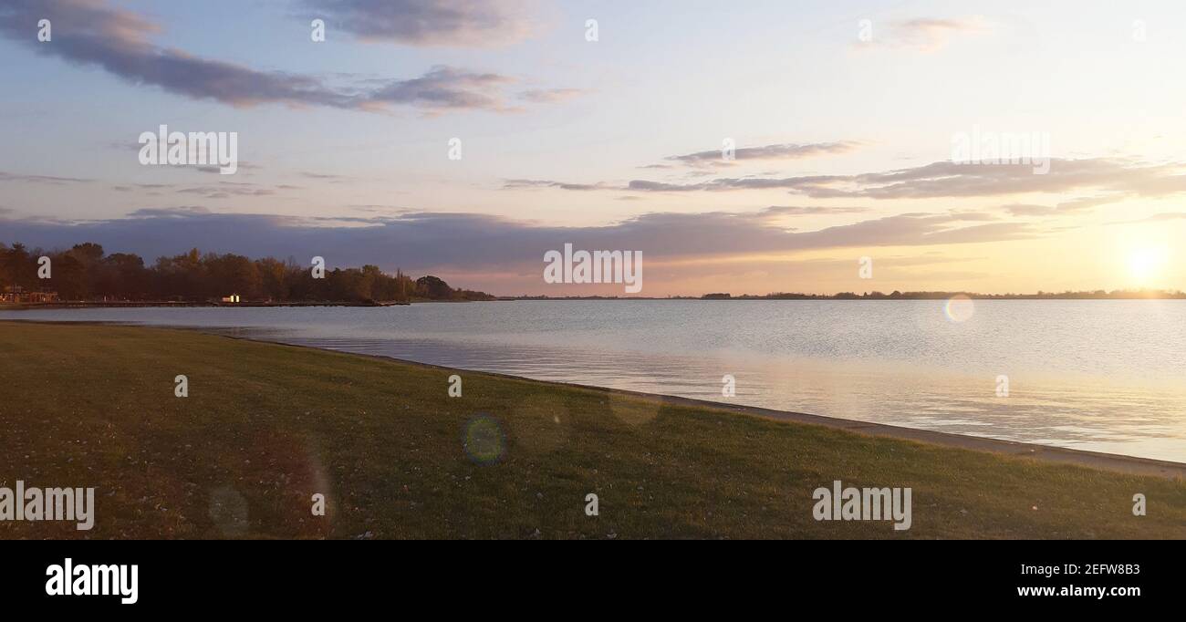 Sunset on the lake. Sunset scene over lake water surface Stock Photo ...