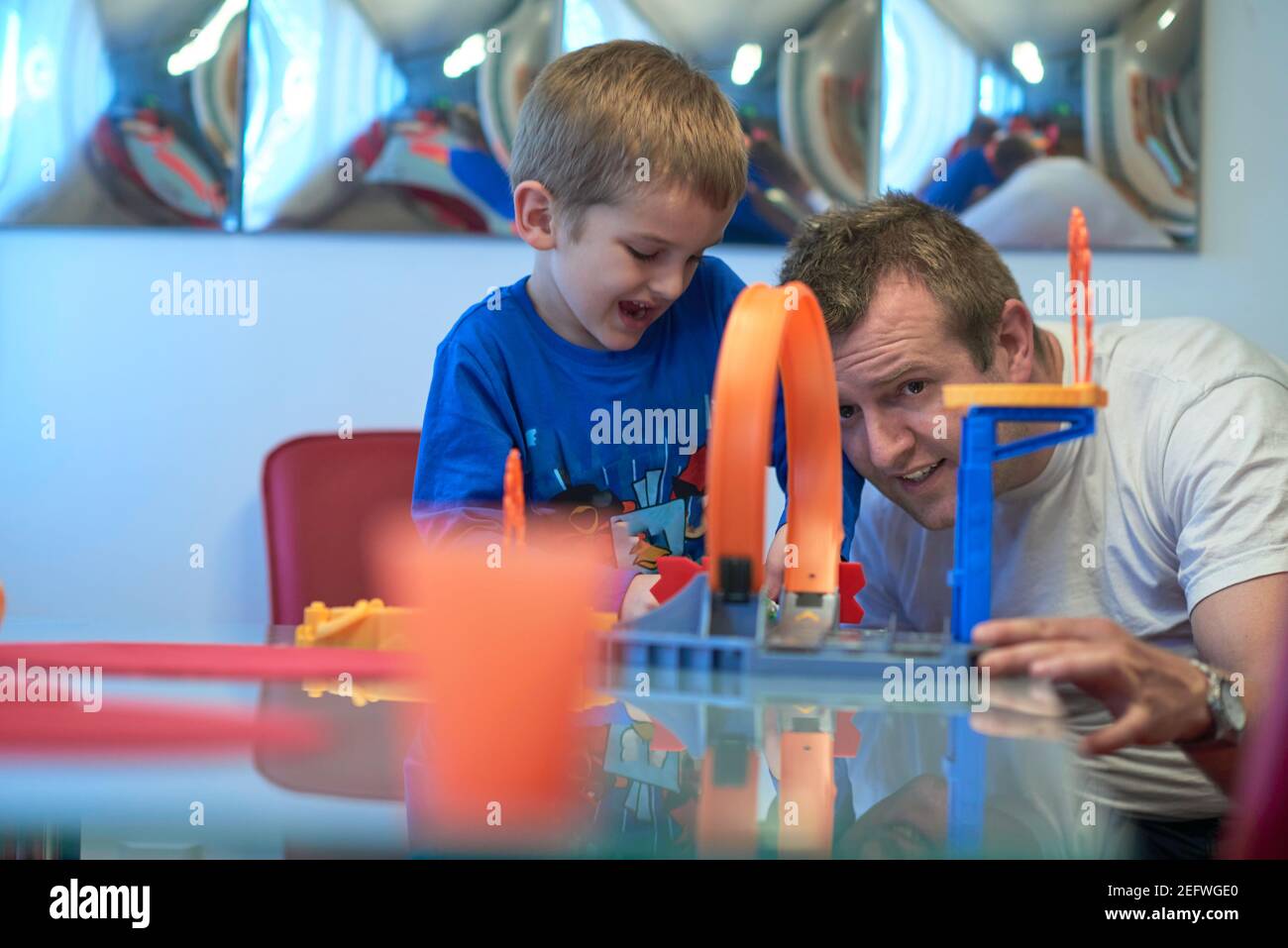 Father and children playing car toy game Stock Photo - Alamy
