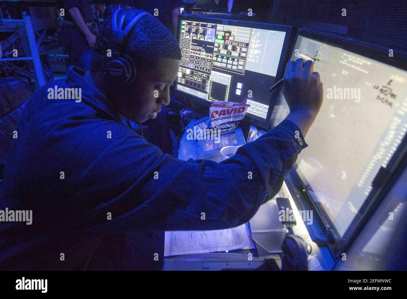 Operations Specialist 1st Class Keith Tatum stands watch in the Combat ...