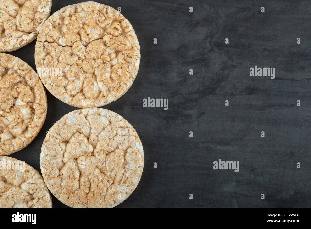 Crispy rice cakes on black wooden background Stock Photo - Alamy