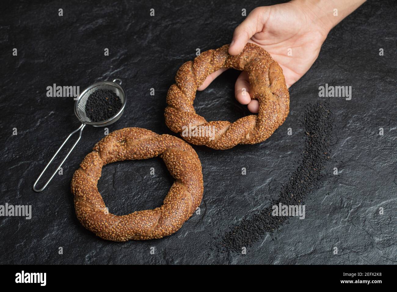 Turkish crunchy round braided bagels with sesame seeds Stock Photo - Alamy