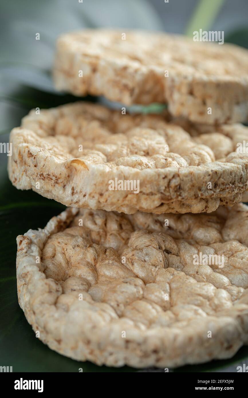 Three puffed rice cakes on green leaf Stock Photo - Alamy
