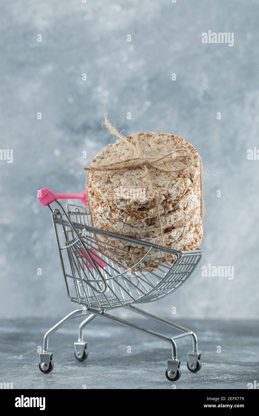 Stack of delicious crispbread in small shopping cart Stock Photo - Alamy