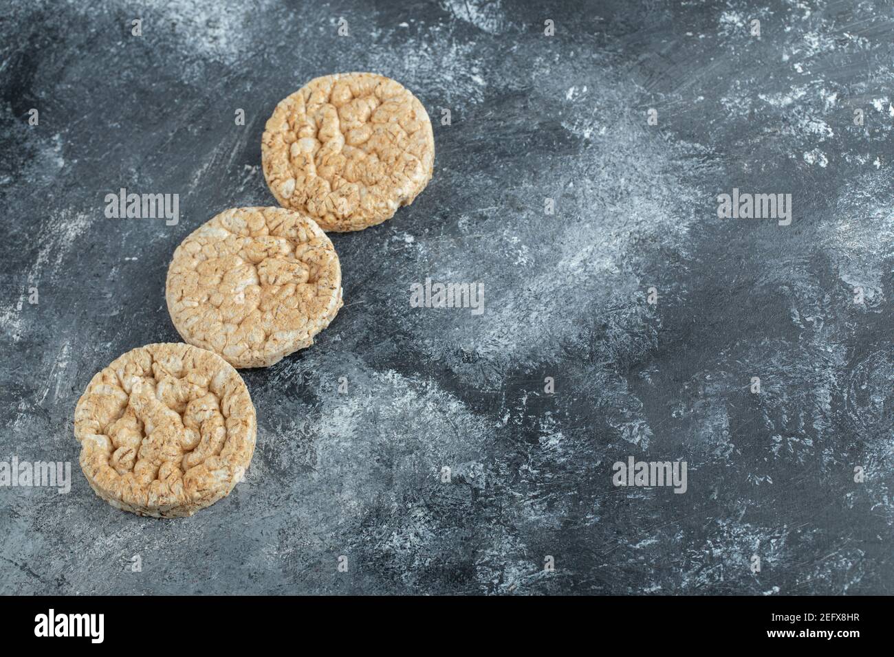 Three puffed rice cakes on marble background Stock Photo - Alamy