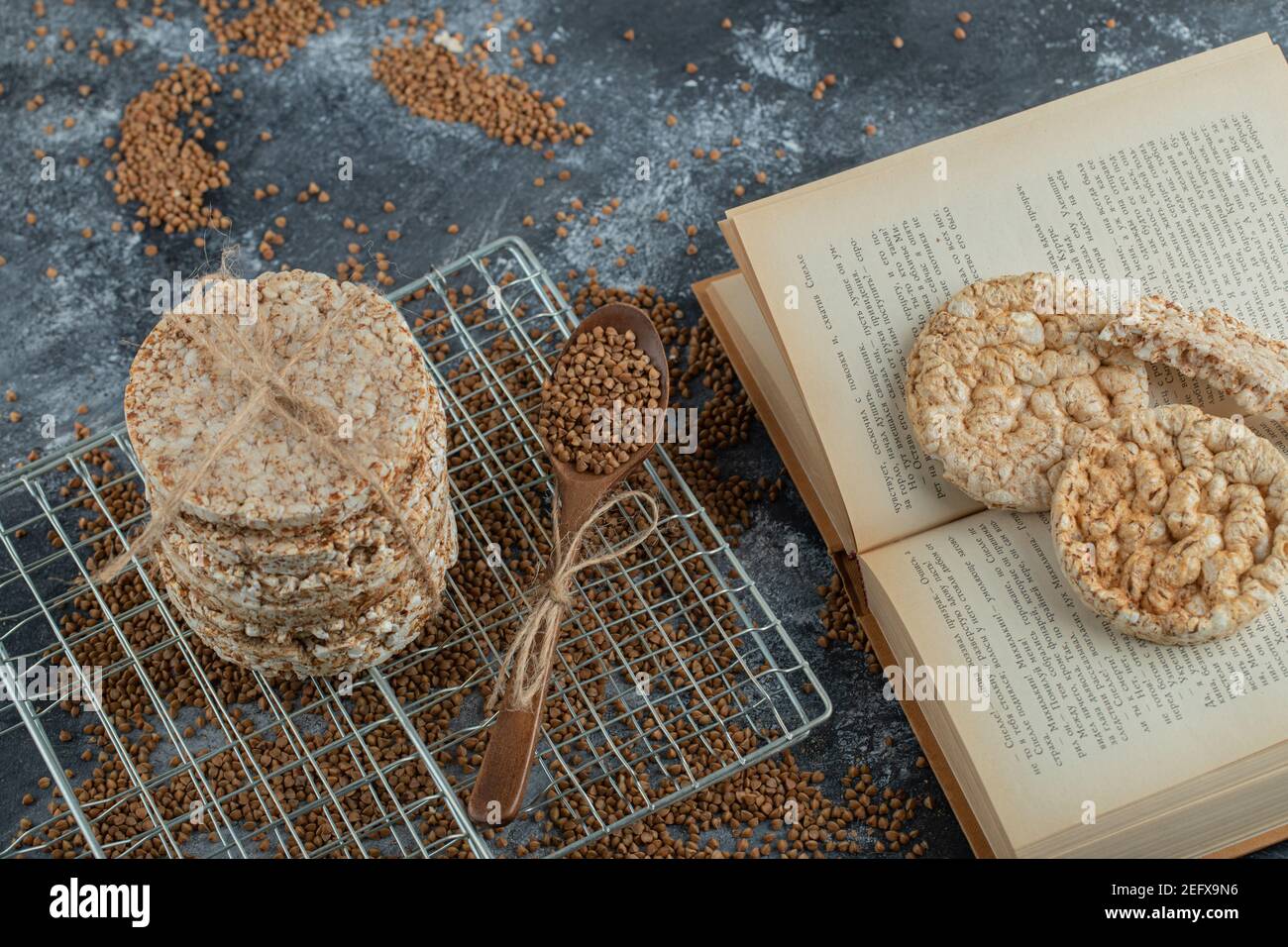 Stack of rice cakes, buckwheat and book on marble surface Stock Photo ...
