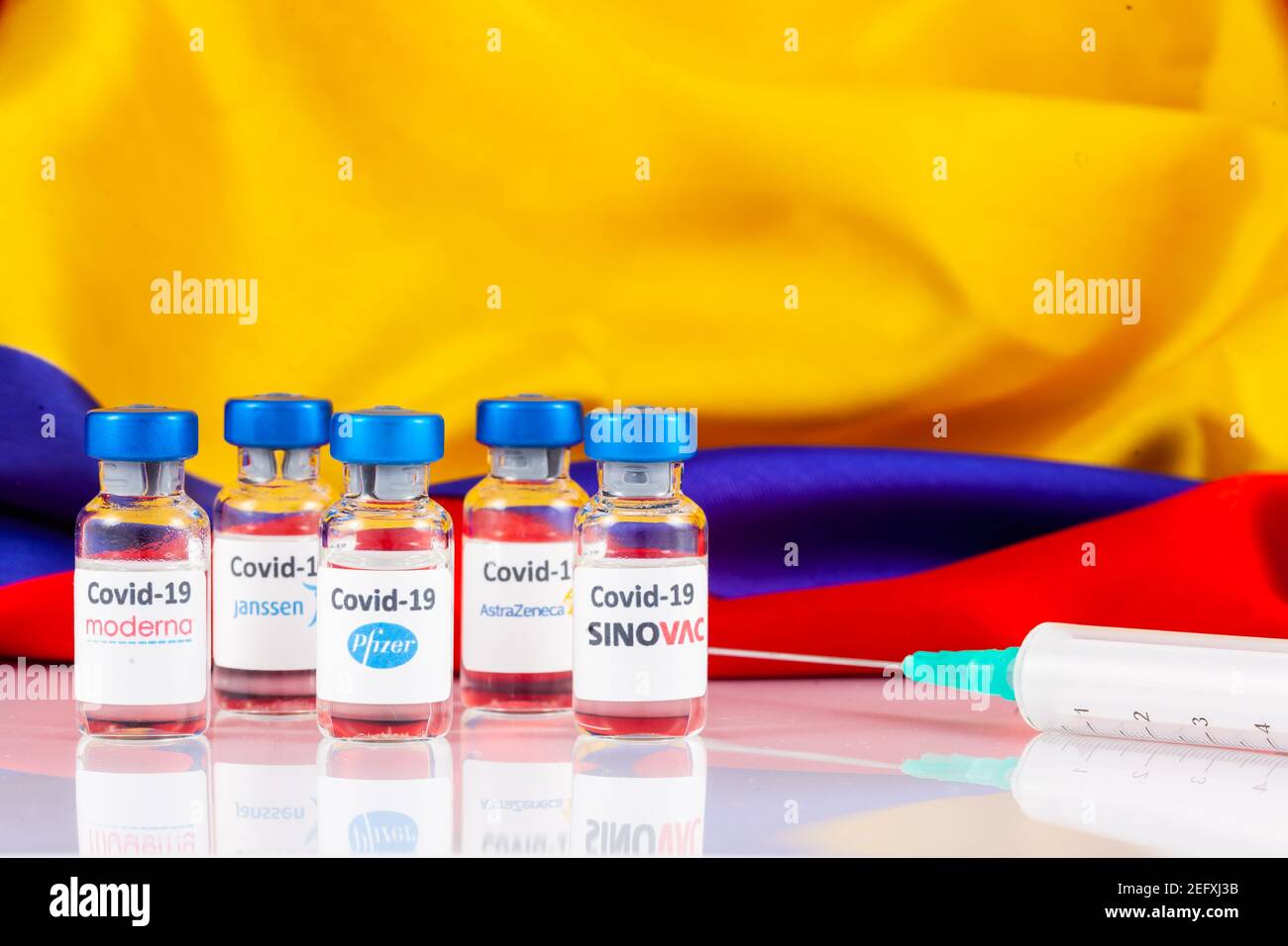 BOGOTA, COLOMBIA - FEBRUARY 2021. Vaccine vials and Colombian flag ...