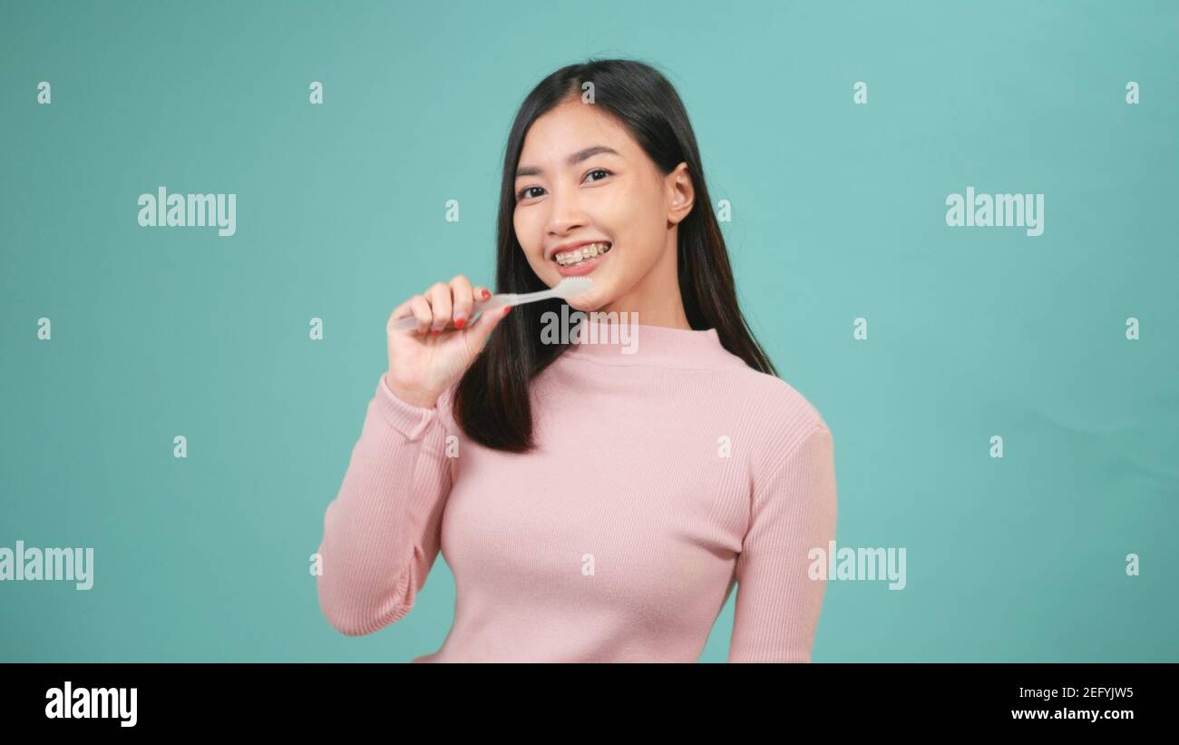 Asian young beautiful woman smile brushing teeth dancing enjoying music ...