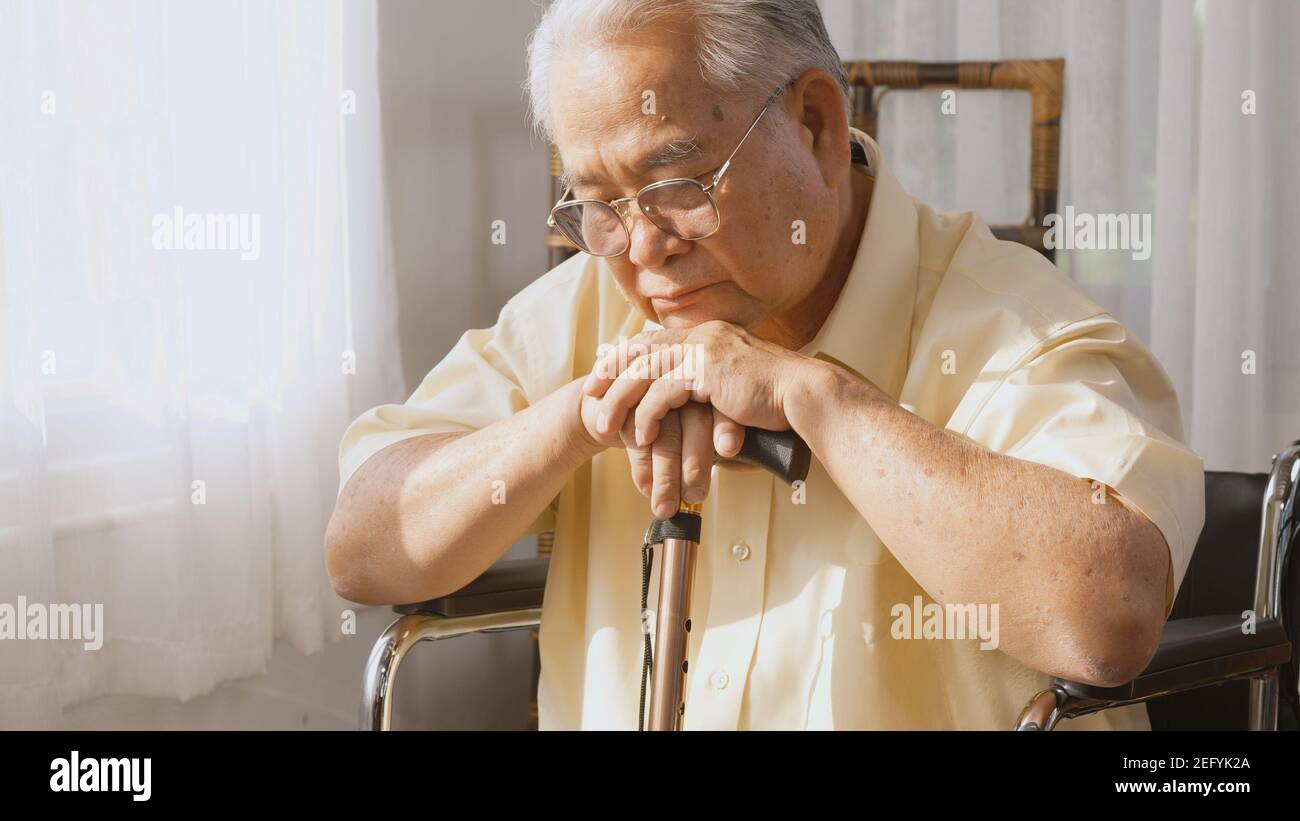 Pensive disabled elderly patient sit on wheelchair alone, Sad and ...