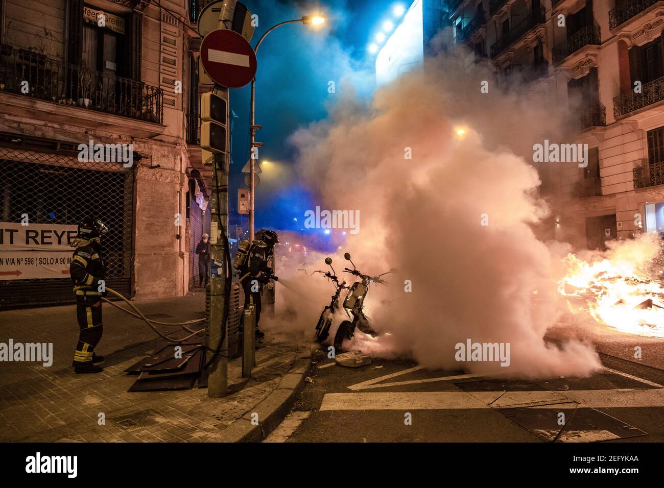 Firefighters are seen putting out the barricade on Balmes street on the ...