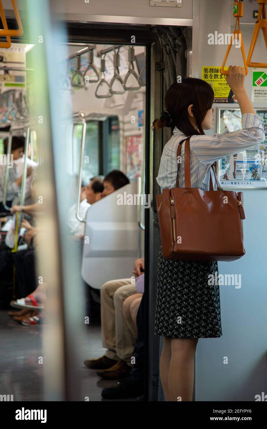 Woman office worker stands on the subway in Tokyo,Japan Stock Photo - Alamy