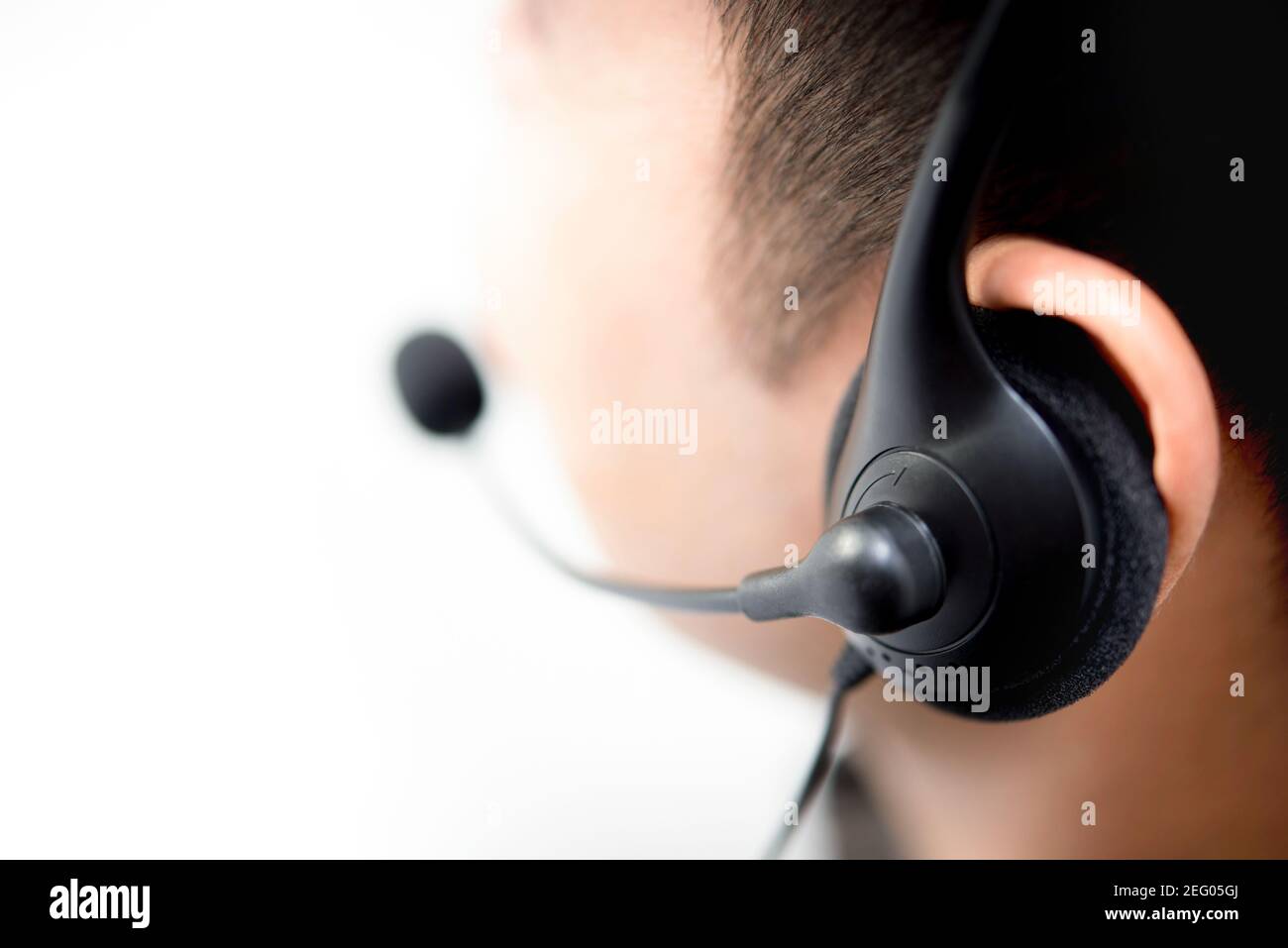 Close up of a man wearing microphone headset, back view Stock Photo - Alamy