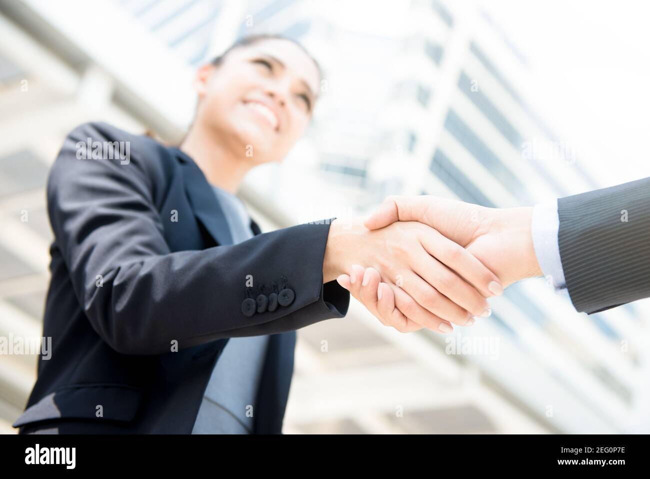 Business woman leader making handshake with her partner - greeting and ...