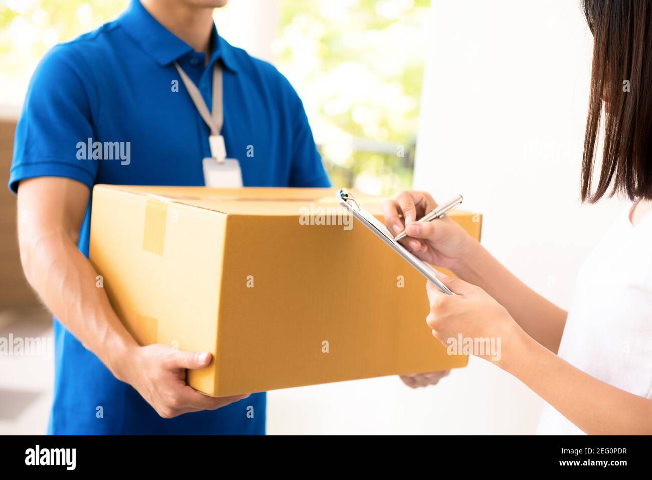 Woman receiving order from hi-res stock photography and images - Alamy