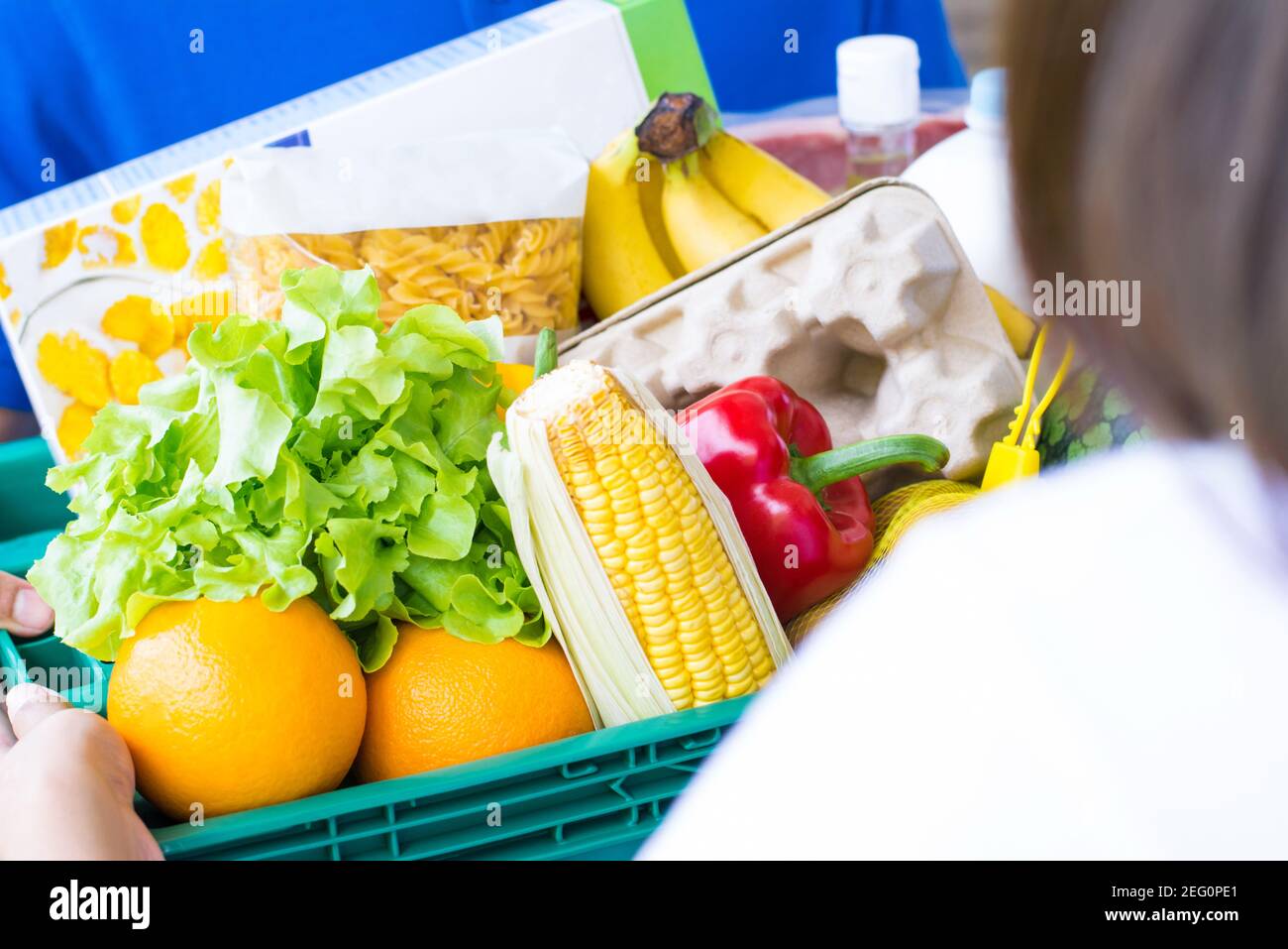 Delivery man delivering food to a woman - online grocery shopping ...