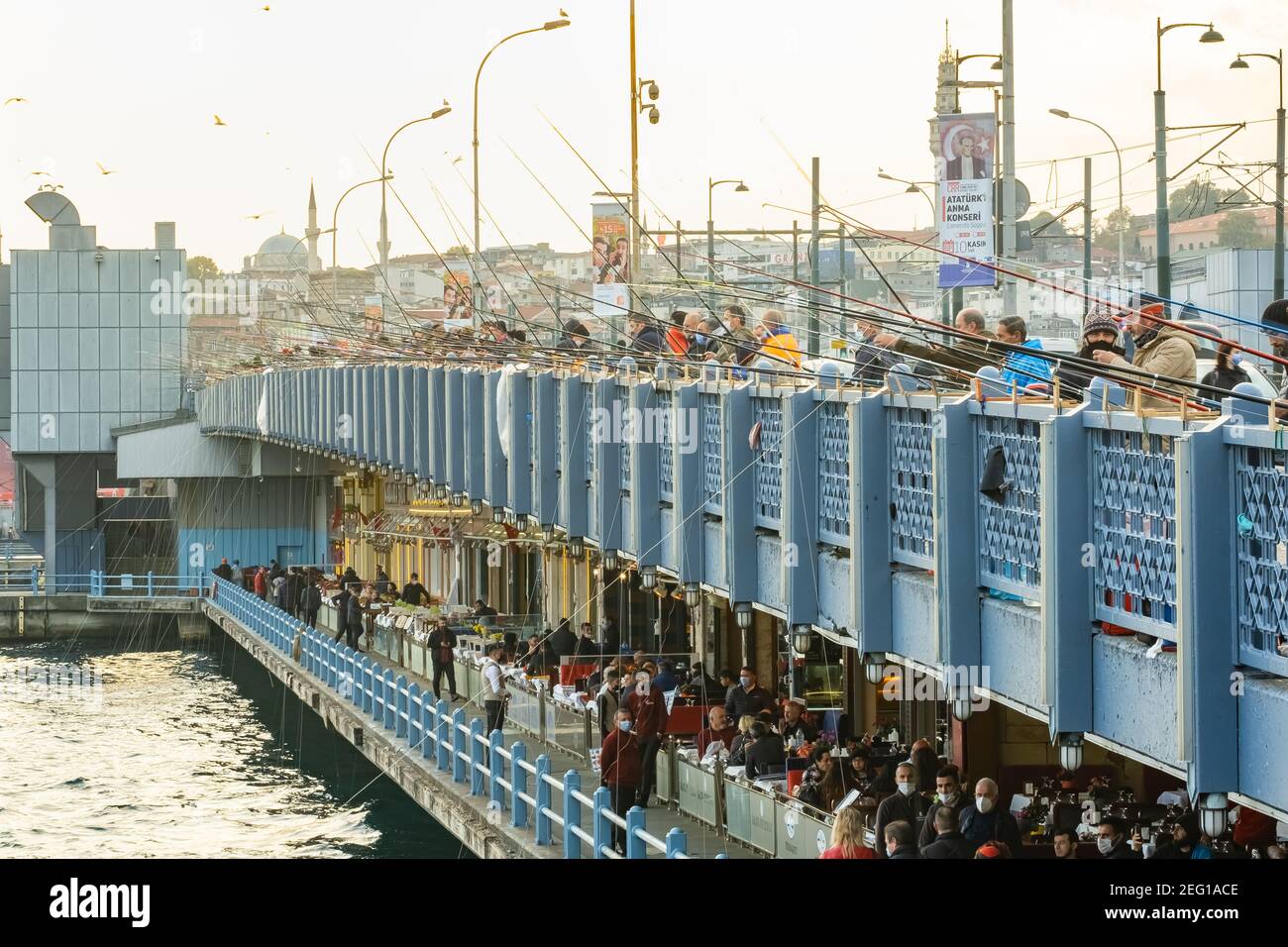 Galata Bridge, restaurants and fisherman fishing on the bridge in ...
