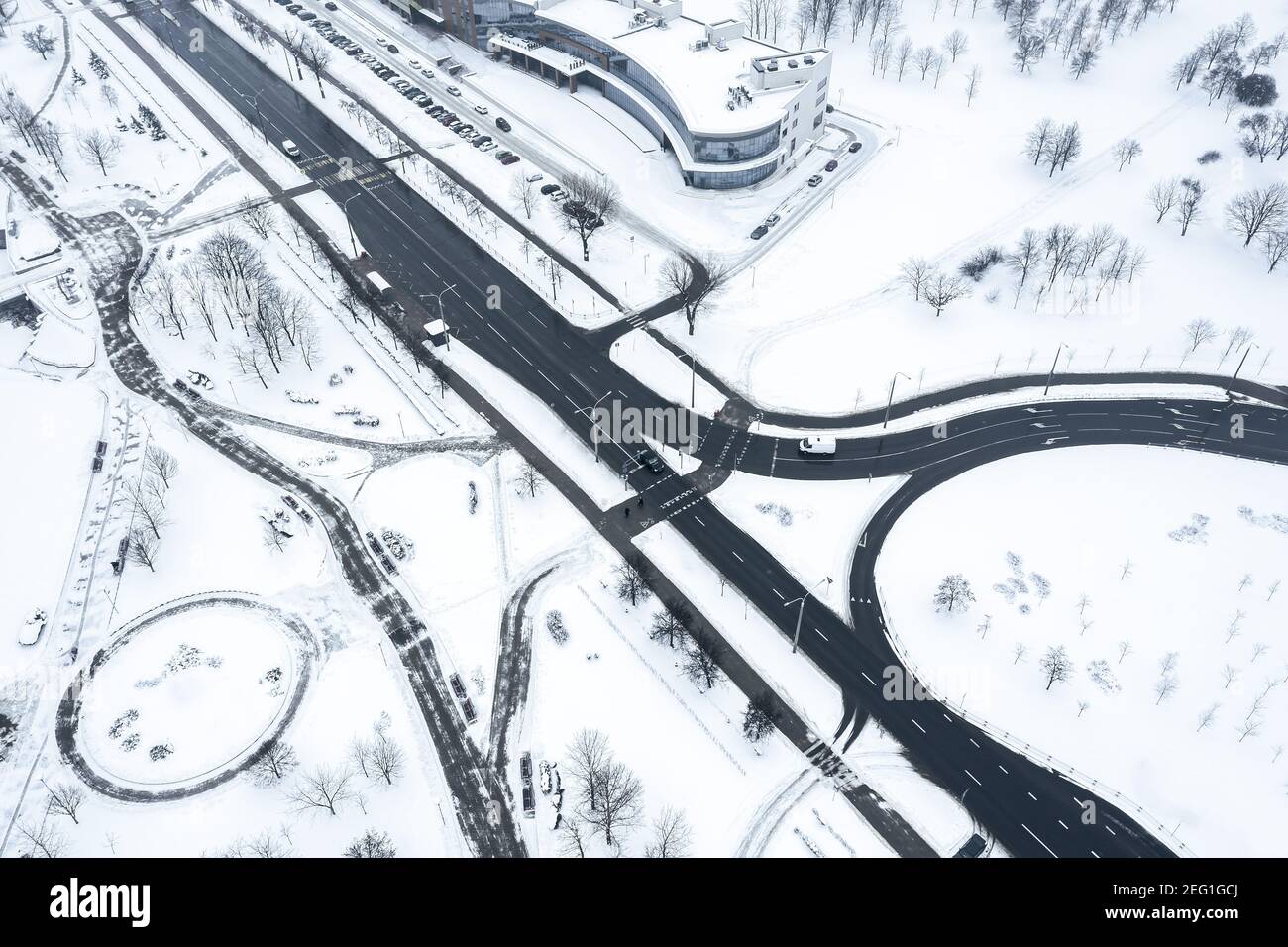 aerial view of winter snow-covered cityscape with road intersections ...