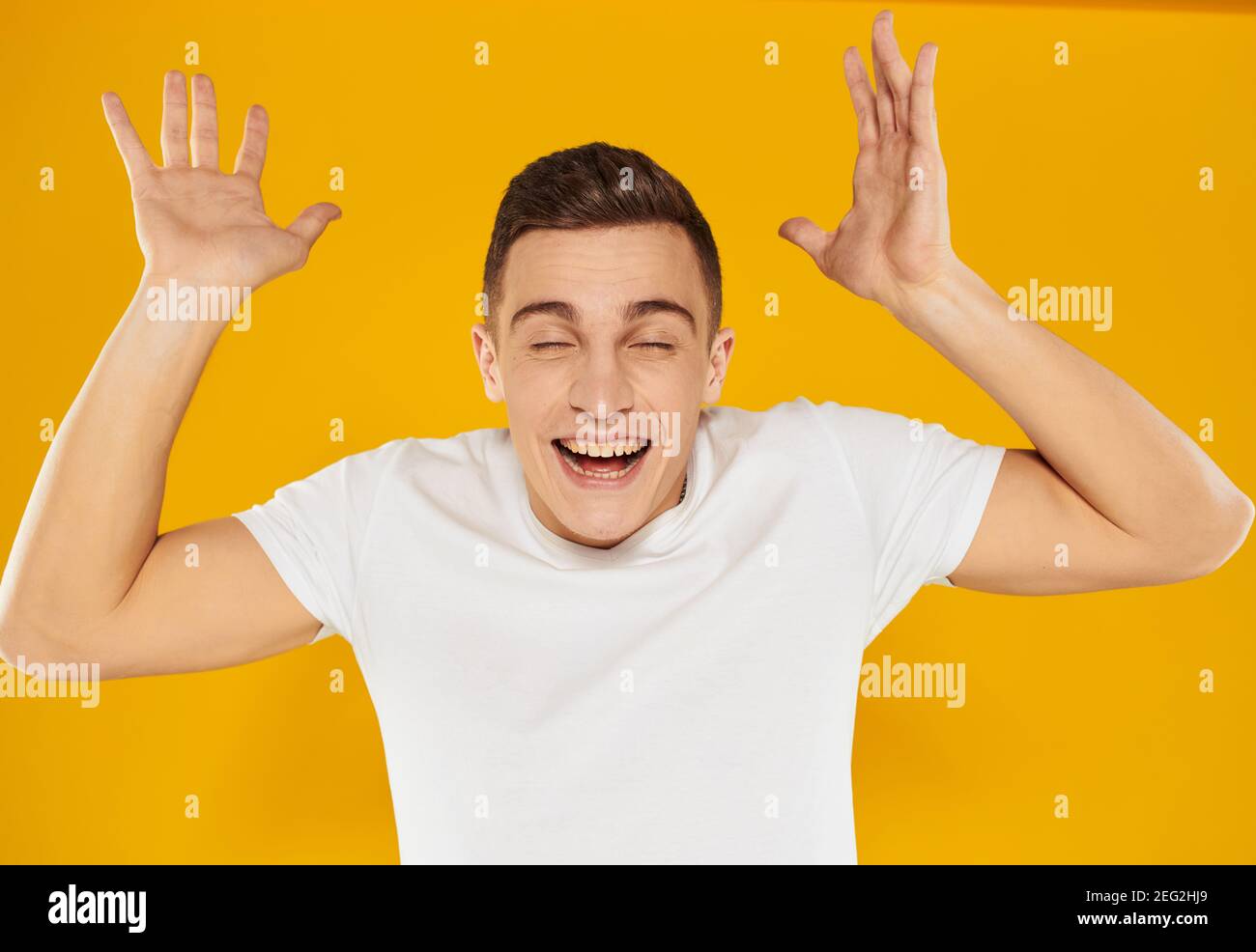 Man gesturing with his hands near the face emotions model yellow ...
