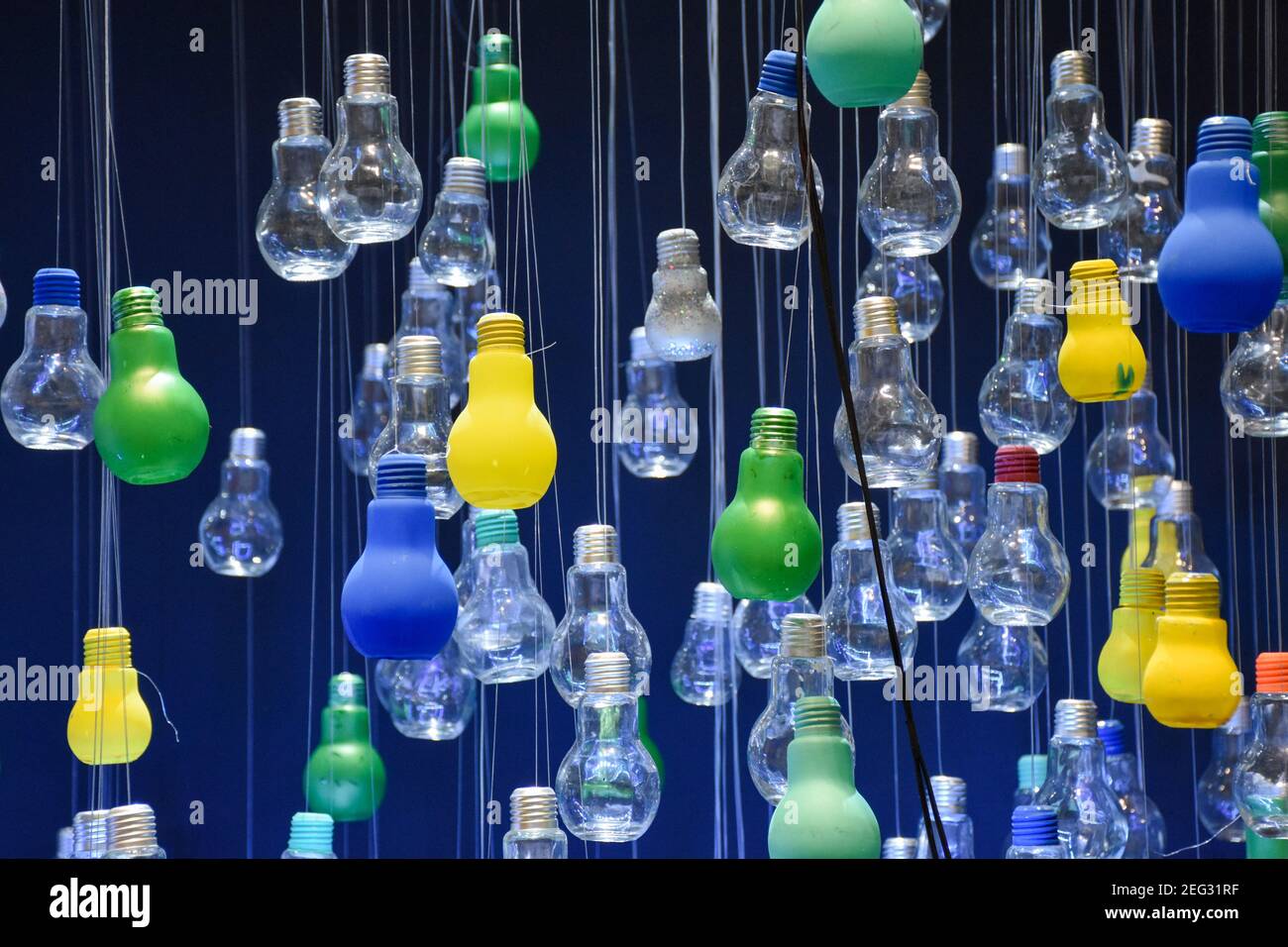 Multi-colored bulbs hanging from the ceiling Stock Photo - Alamy