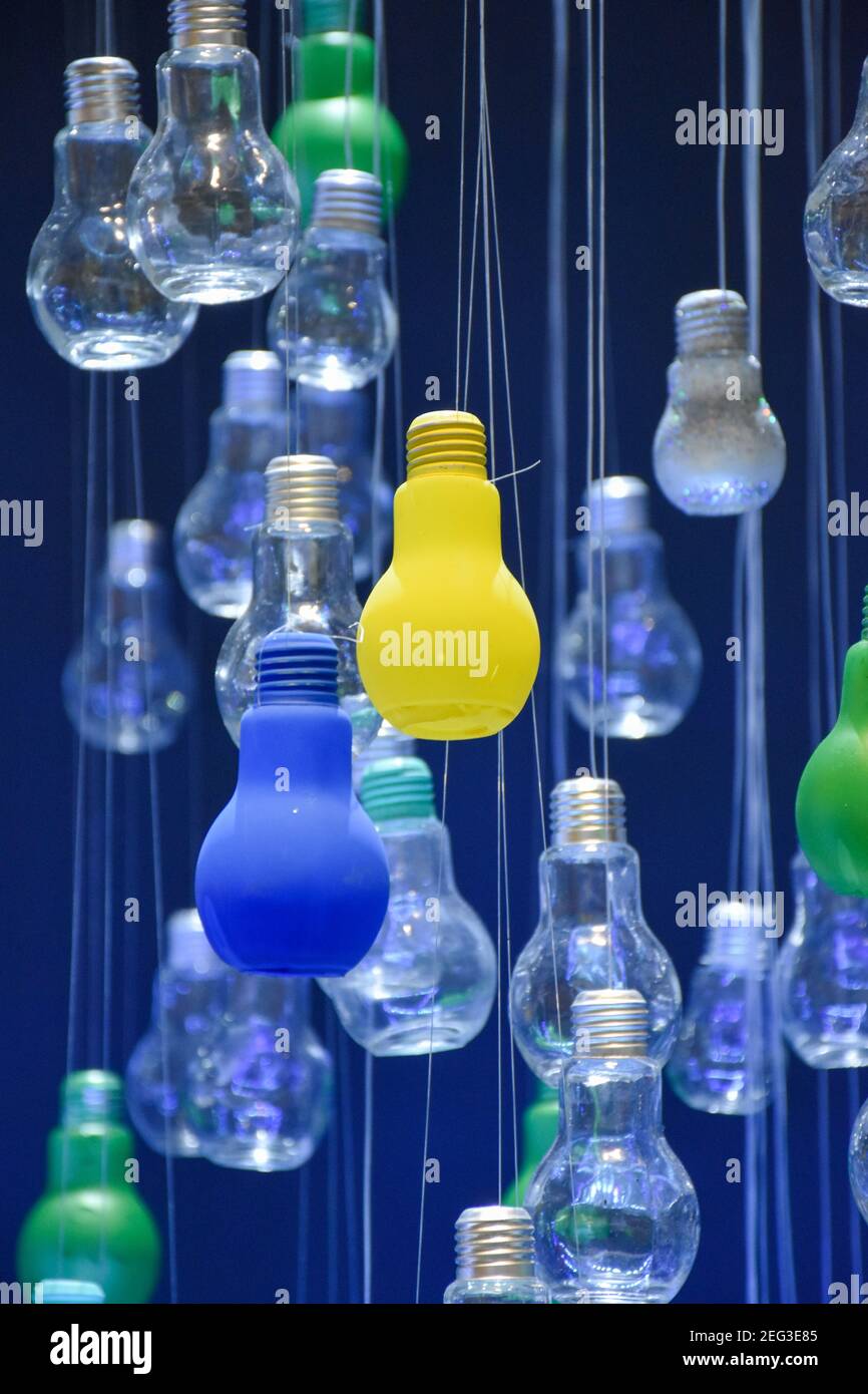 Multi-colored bulbs hanging from the ceiling Stock Photo - Alamy