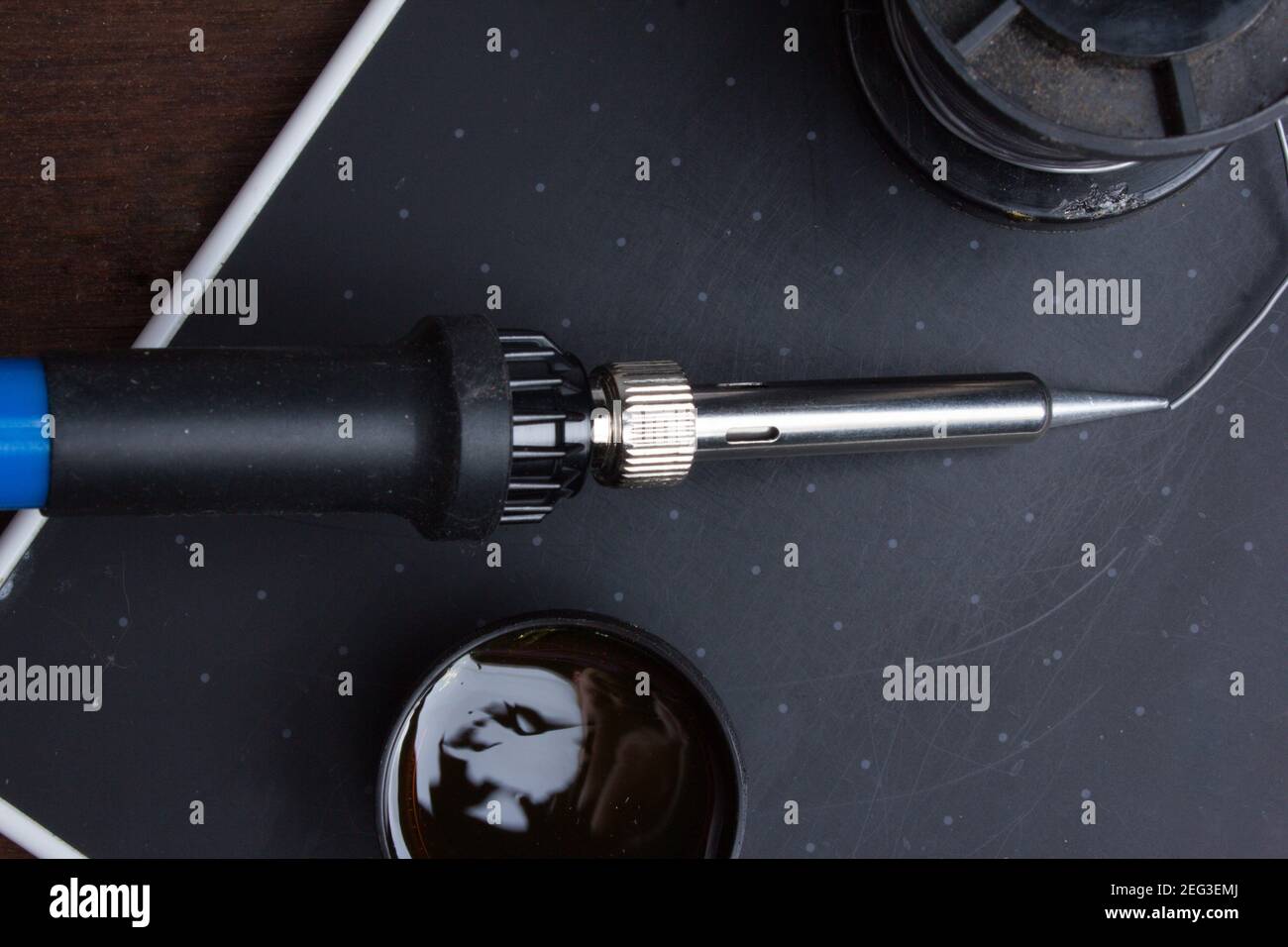 Soldering tools. Soldering iron, and rosin, on a black background Stock ...